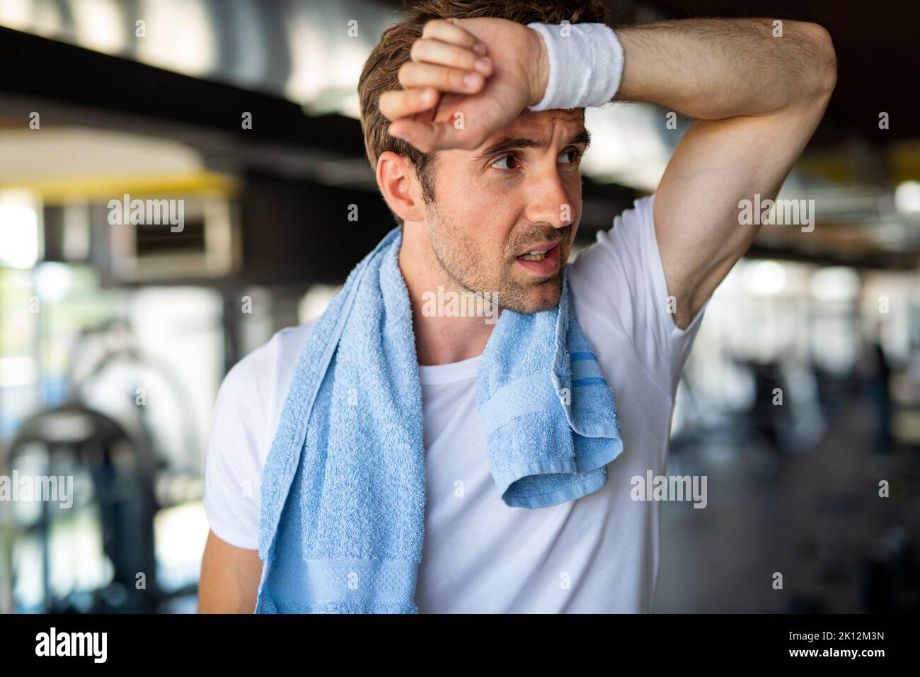 Fit man taking a break from working out at the gym. Stay healthy ...