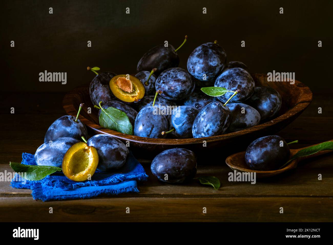 Ripe blue Fresh organic sweet plums just picked from the tree, walnut ...