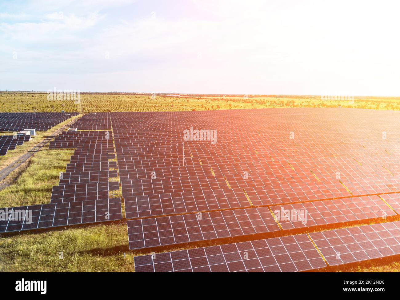 Aerial top view of a solar panels power plant. Photovoltaic solar panels at sunrise and sunset ...