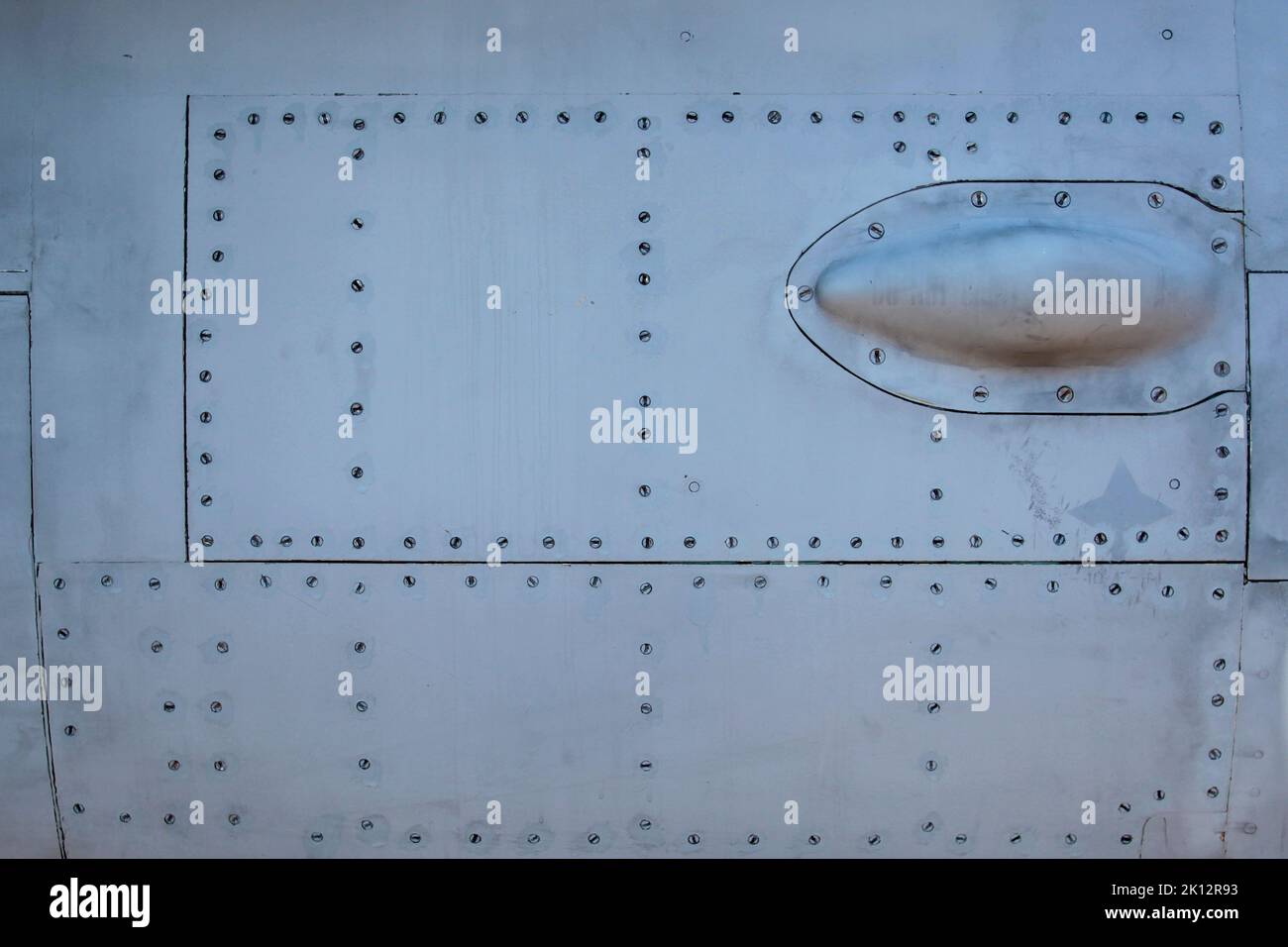 Aluminum, metal, texture with rivets and screws from the side of an air ...