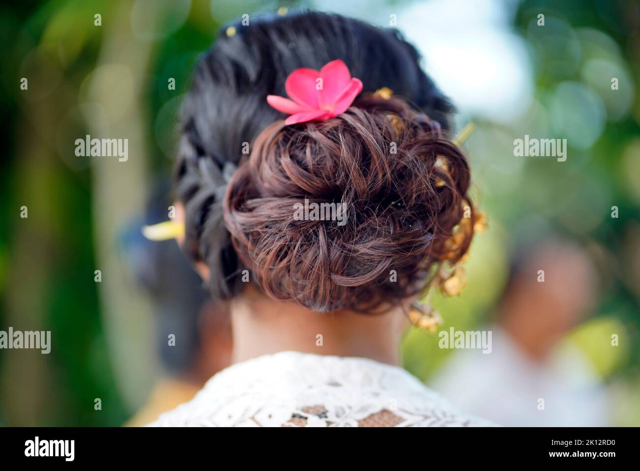 Hair back of Balinese young woman in hair bun and hair braid with Bali ...