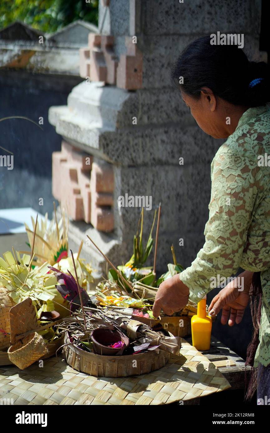 Bali, Indonesia - April 13, 2022 - Balinese Hindu woman preparing some ...