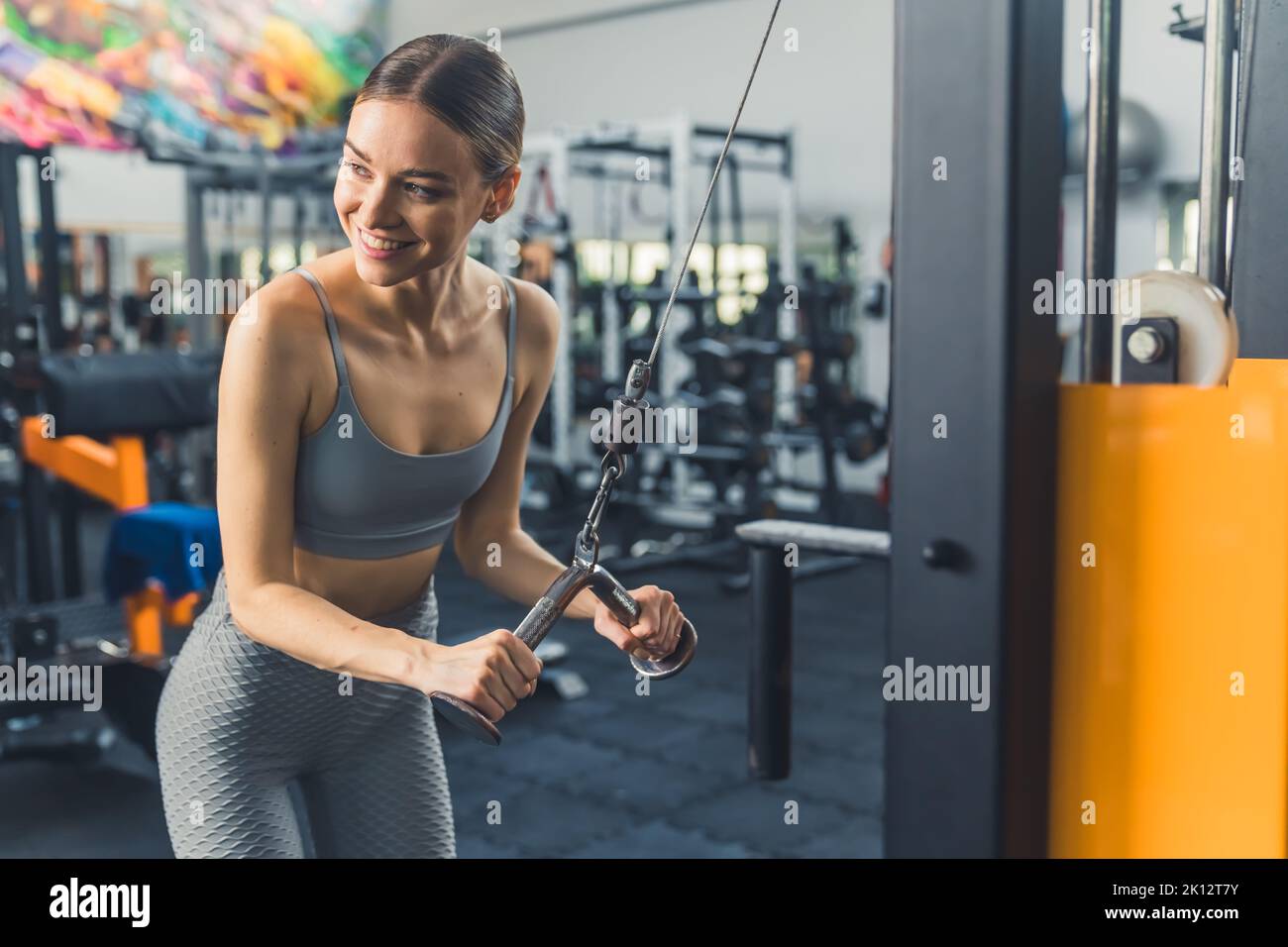 young and beautiful Caucasian girl doing exercising with a rowing ...