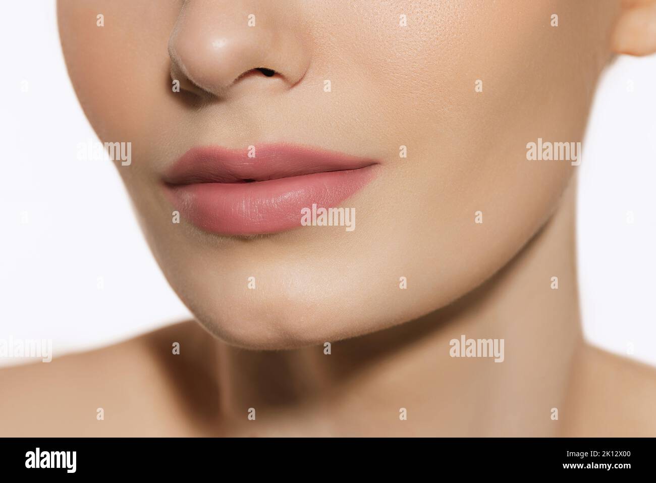 Closeup female lips, cheeks and nose isolated over white studio ...