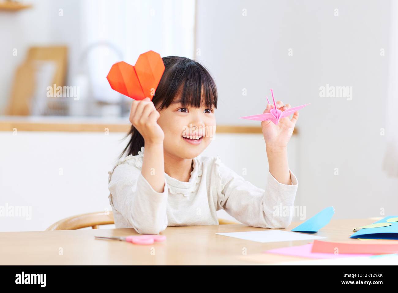 Japanese kid playing with origami at home Stock Photo - Alamy