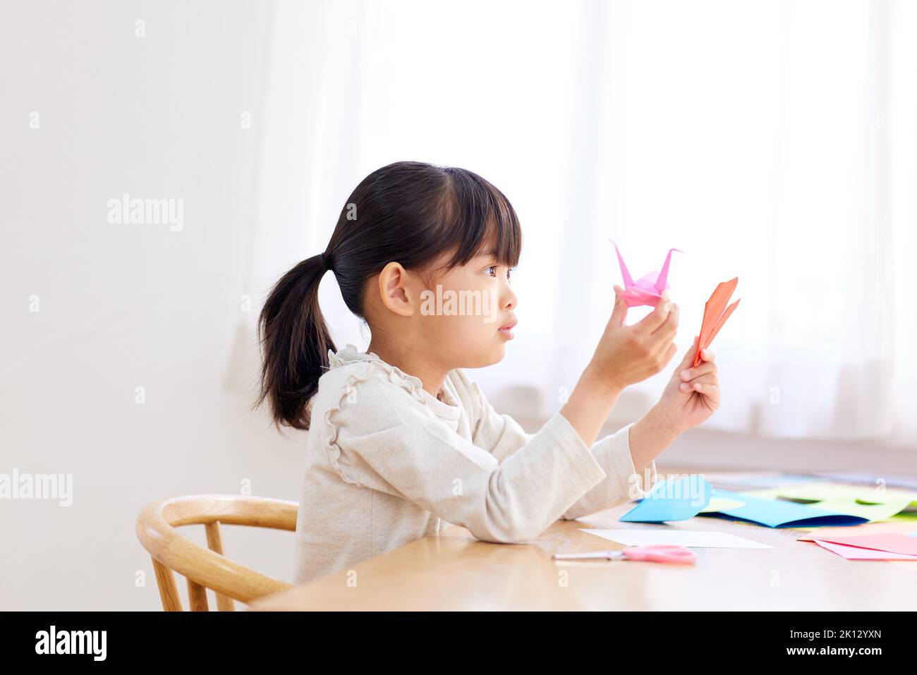 Japanese kid playing with origami at home Stock Photo - Alamy