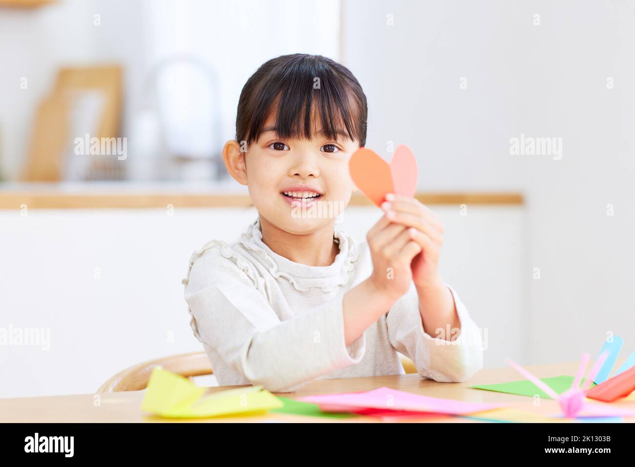 Japanese kid playing with origami at home Stock Photo - Alamy