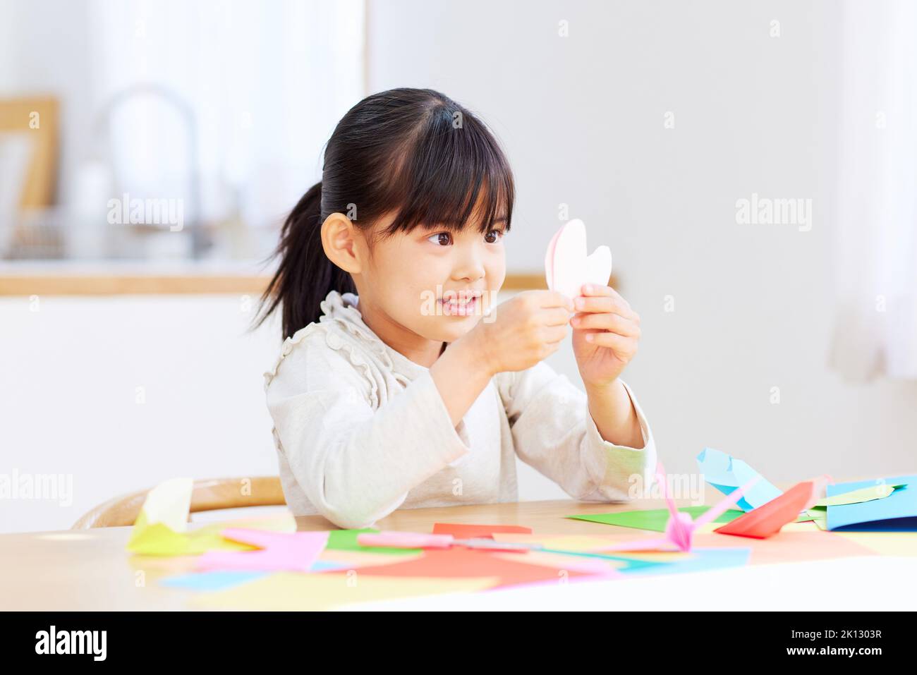 Japanese kid playing with origami at home Stock Photo - Alamy