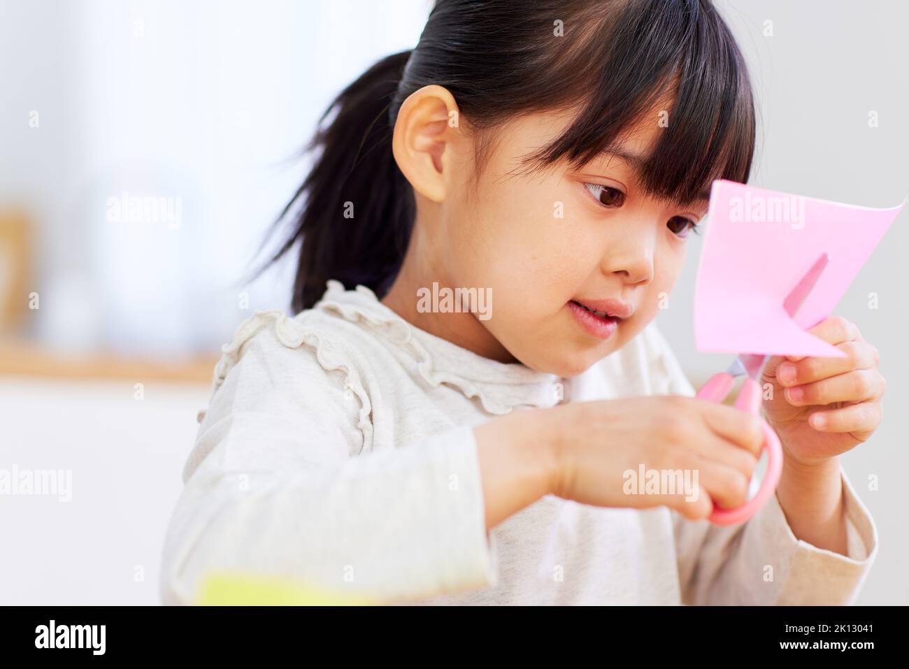 Japanese kid playing with origami at home Stock Photo - Alamy