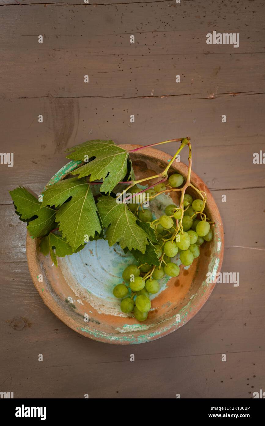green grapes in rustic clay pot Stock Photo - Alamy