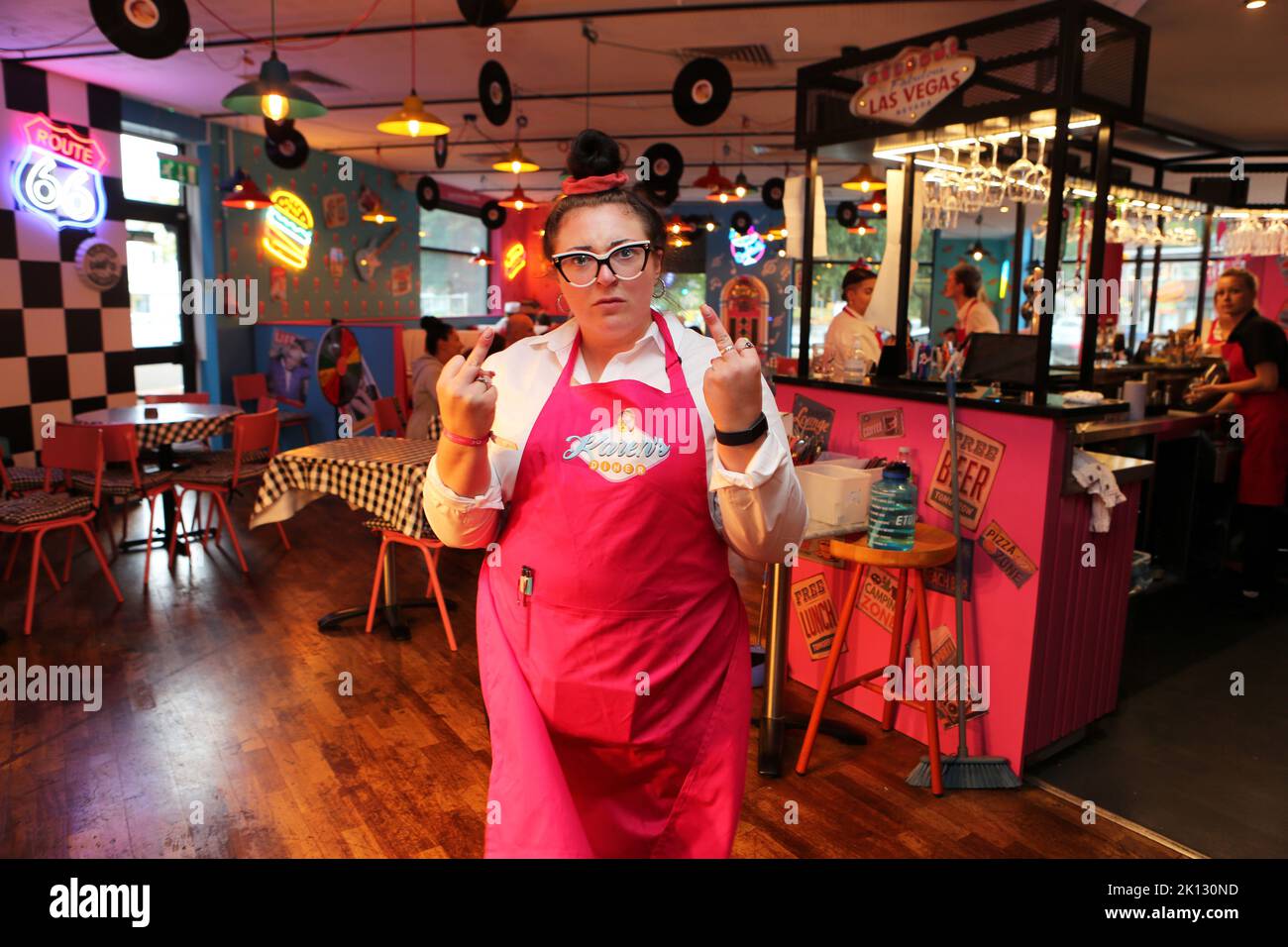 A miserable member of staff gives the photographer the finger at Karen ...