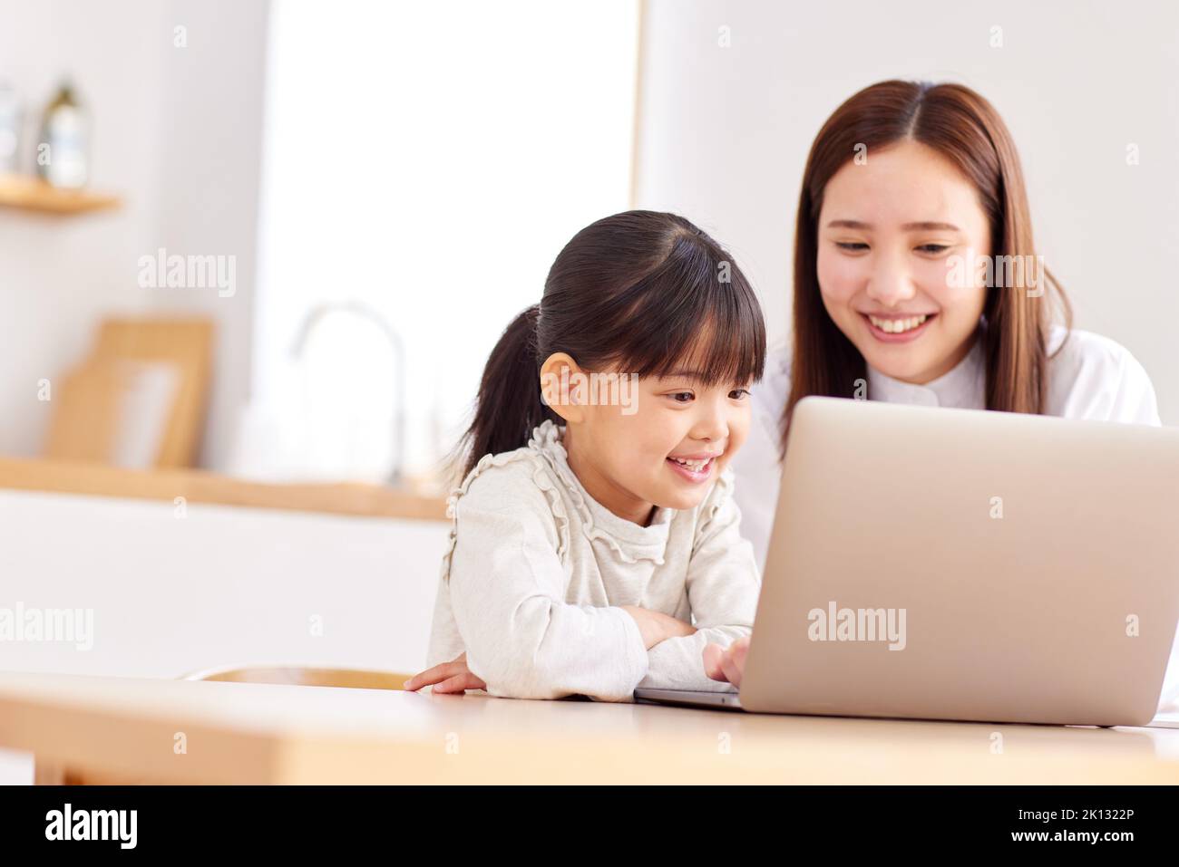 Japanese kid and mother studying at home Stock Photo - Alamy