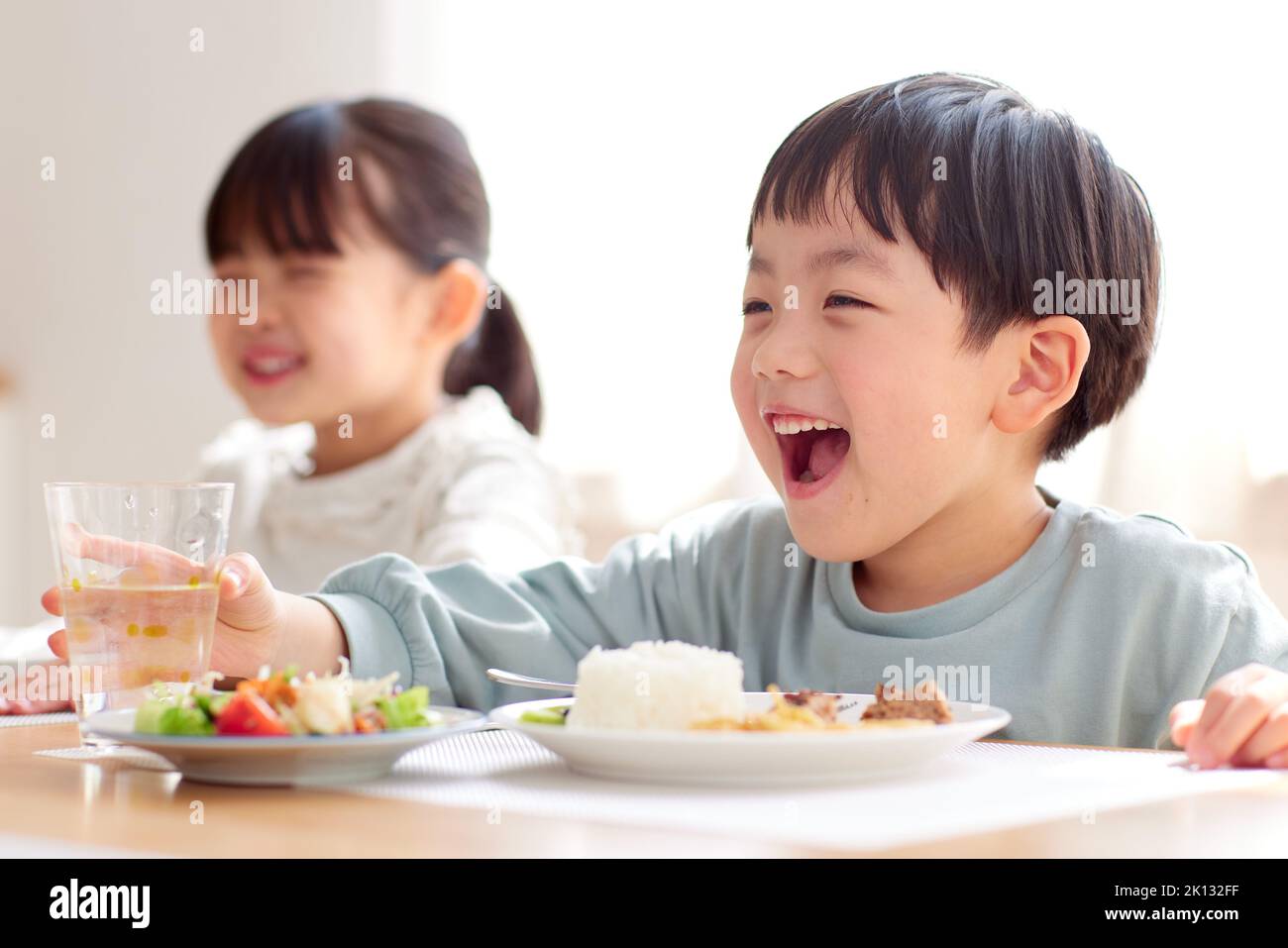 Japanese kids eating together at home Stock Photo - Alamy