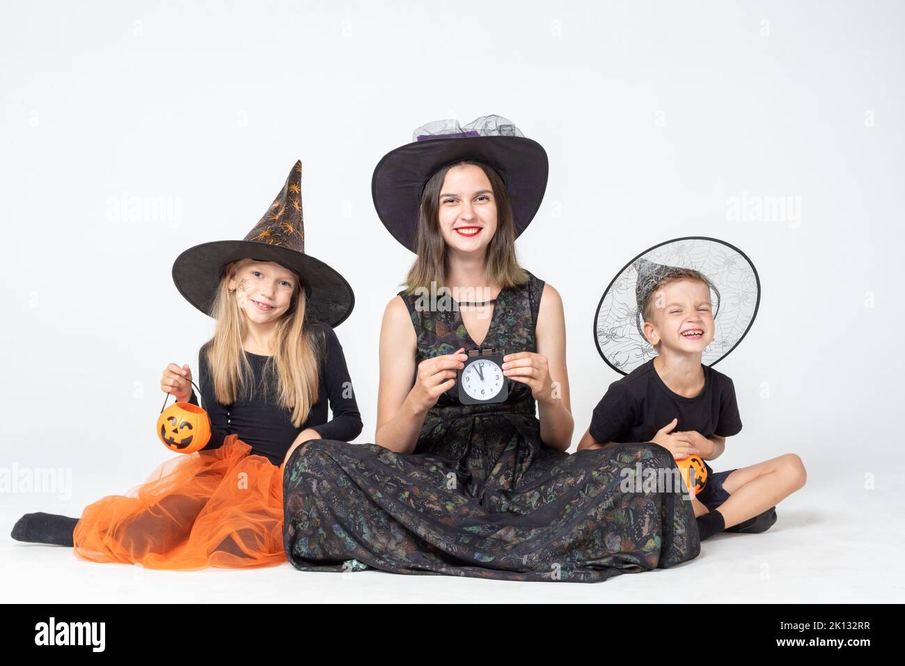 Family Halloween. A happy family, a mother and children in creepy witch ...