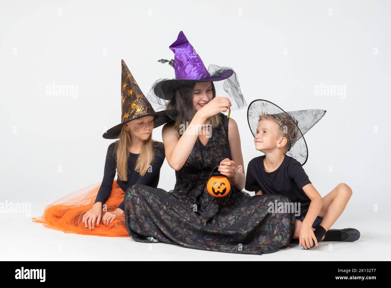 Family Halloween. A happy family, a mother and children in creepy witch ...