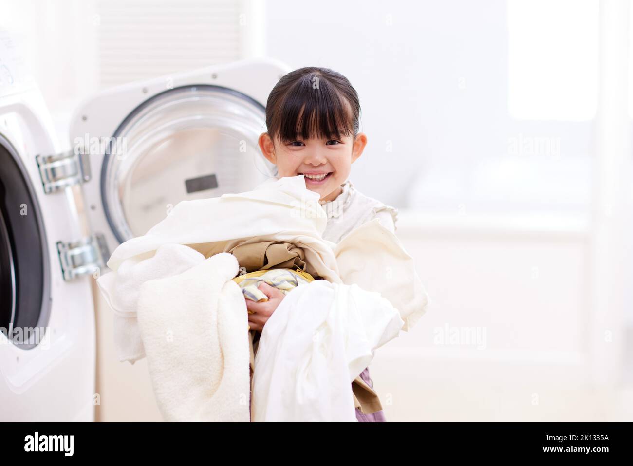 Japanese kid doing laundry at home Stock Photo - Alamy