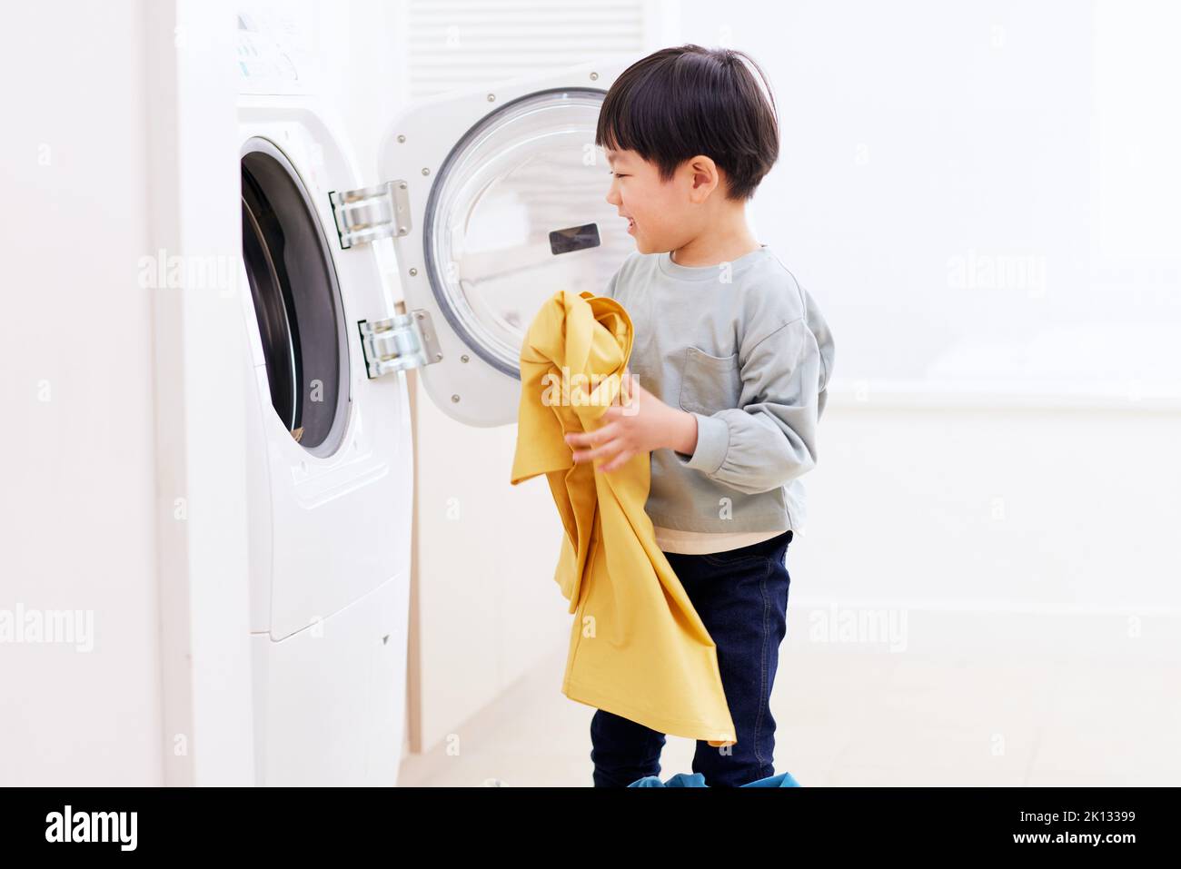 Japanese kid doing laundry at home Stock Photo - Alamy