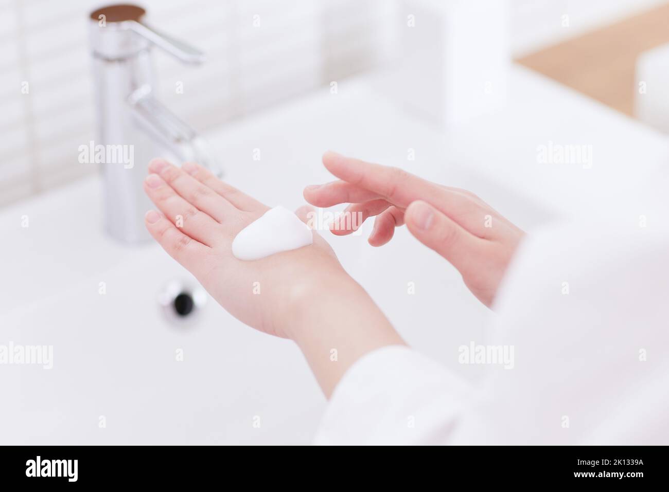 Japanese woman washing hands with foaming hand soap Stock Photo - Alamy