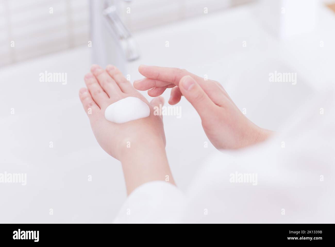 Japanese woman washing hands with foaming hand soap Stock Photo - Alamy