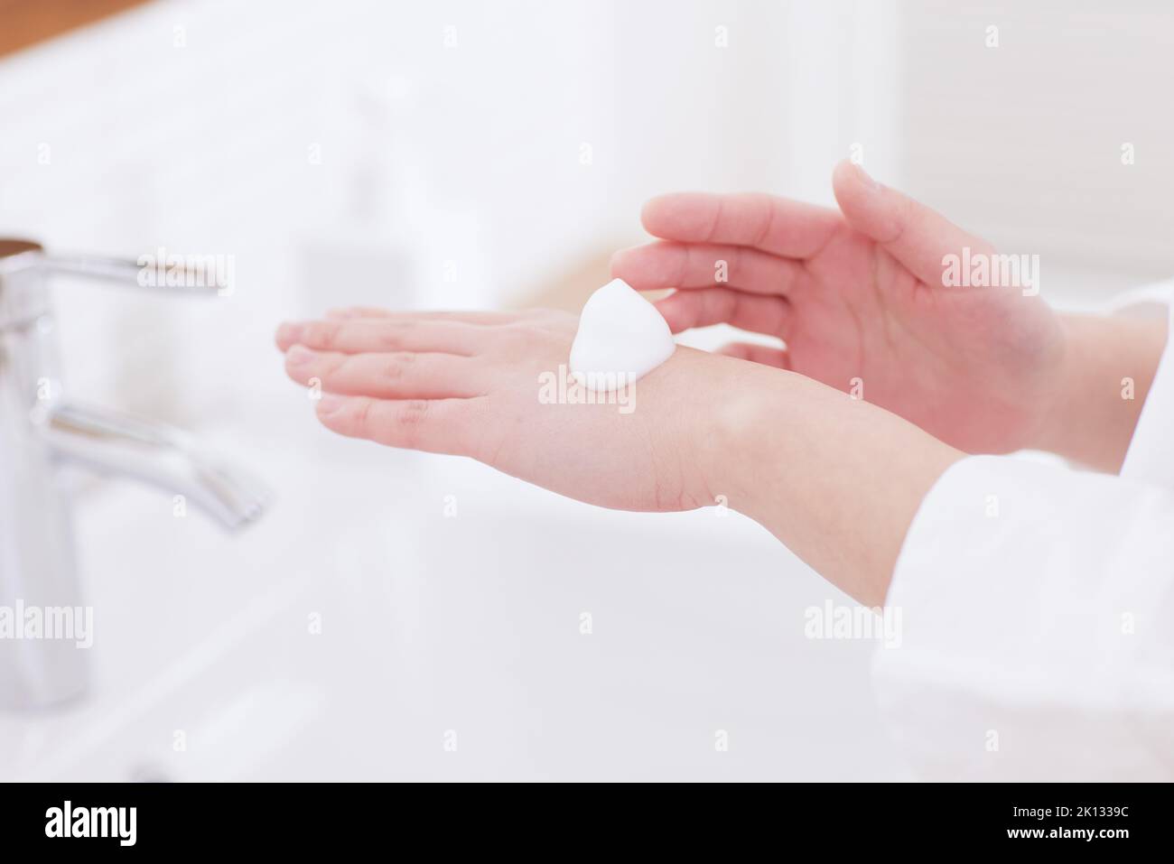 Japanese woman washing hands with foaming hand soap Stock Photo - Alamy