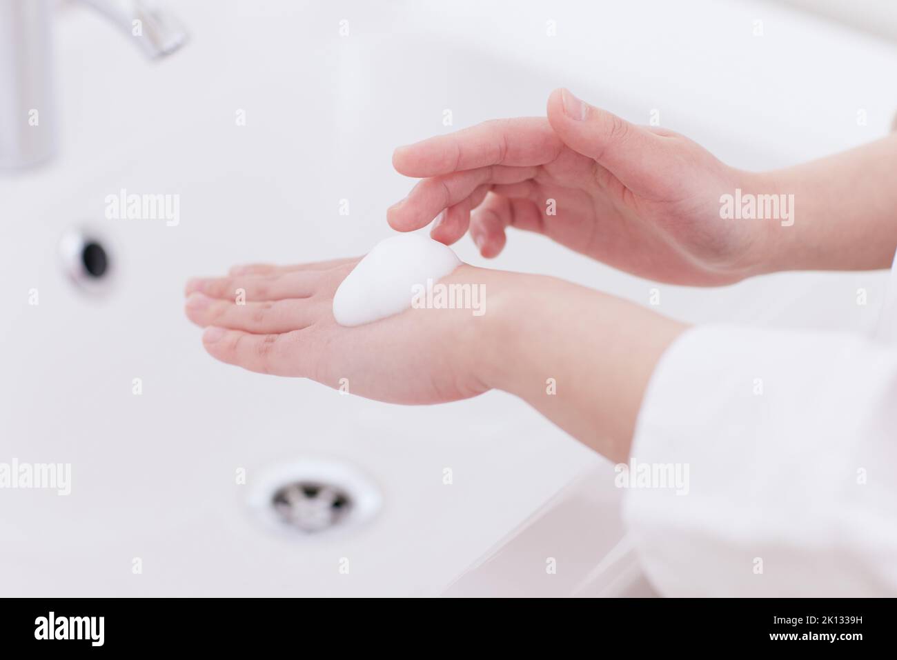 Japanese woman washing hands with foaming hand soap Stock Photo - Alamy