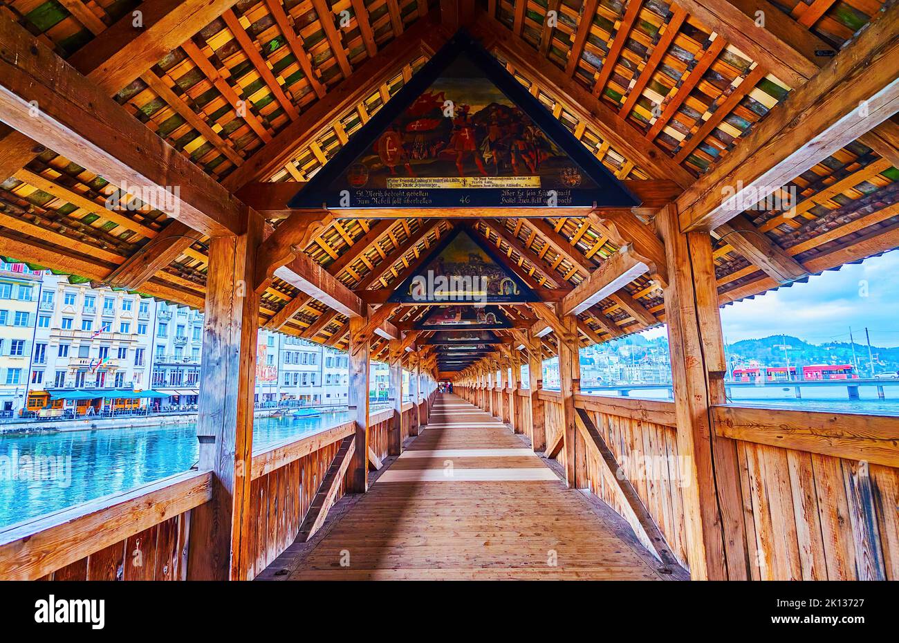 Medieval pictures under the roof of covered wooden Kapellbrucke bridge ...