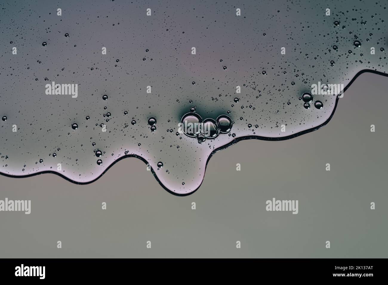 Liquid serum, gel bLiquid serum, gel bubbles background. In light ...