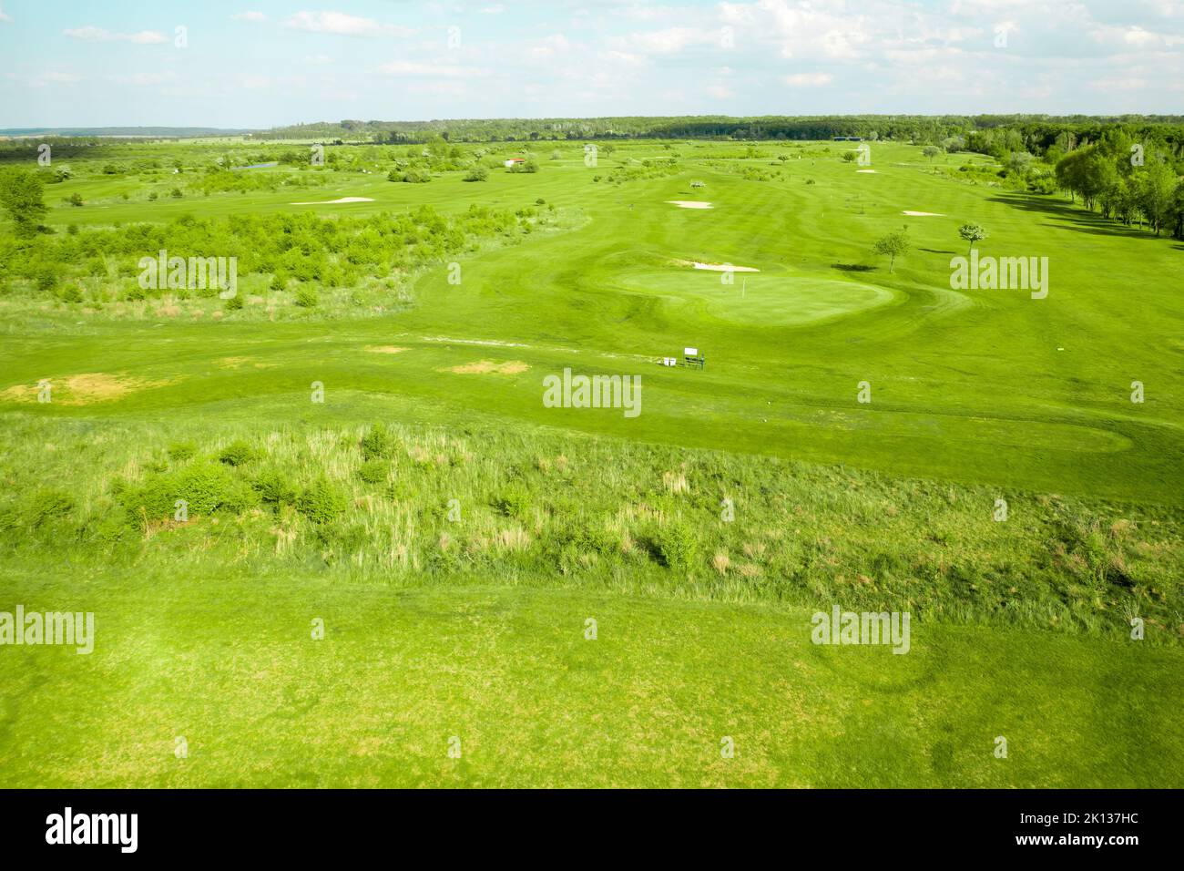 View from a distance of the golf course from a height. Green field and ...