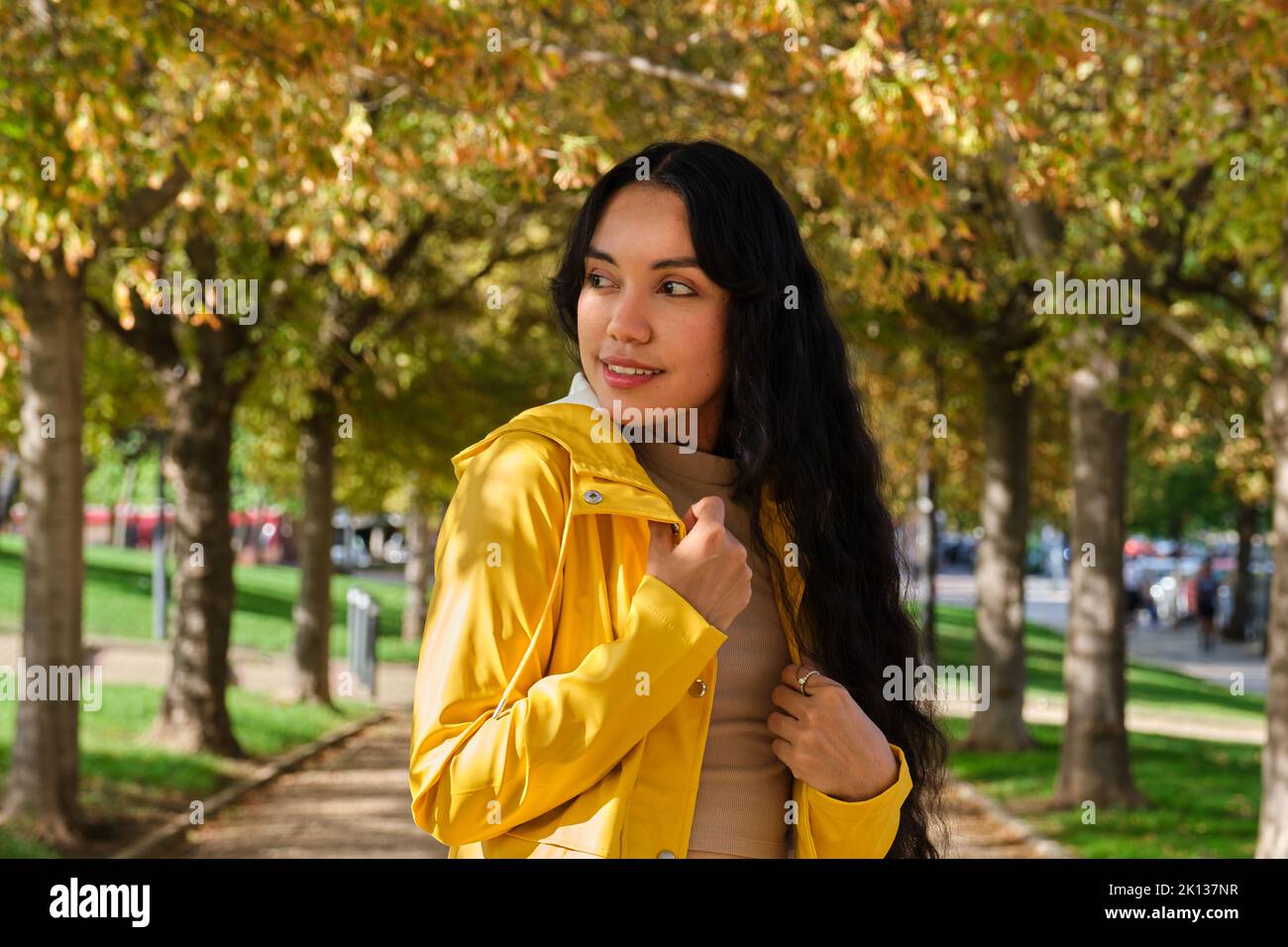 Young latin girl dressed in yellow raincoat smiling Stock Photo - Alamy