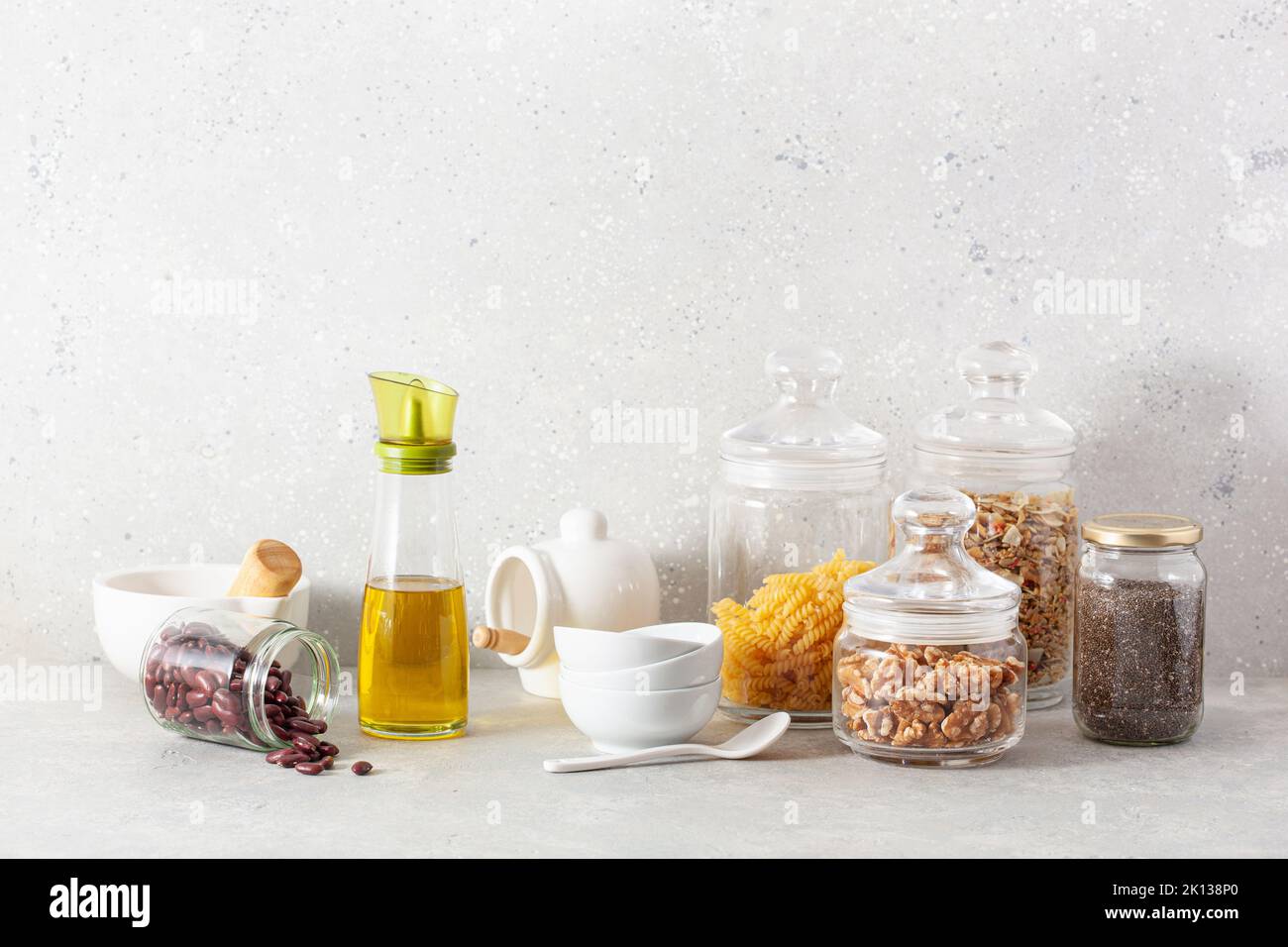 kitchen utensils on modern simple counter, kitchenware jars with dry ...