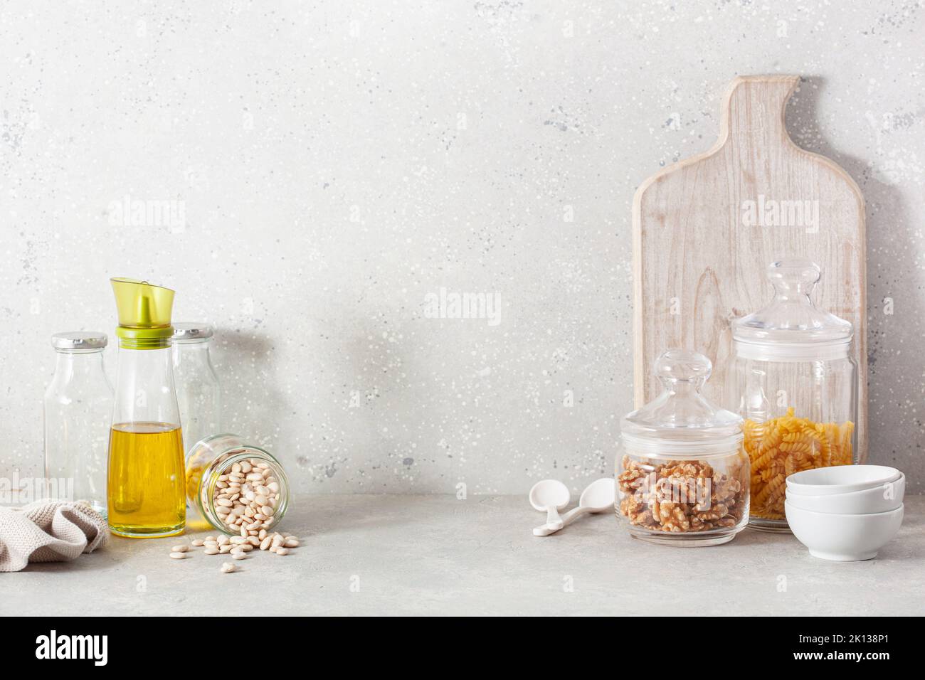 kitchen utensils on modern simple counter, kitchenware jars with dry ...