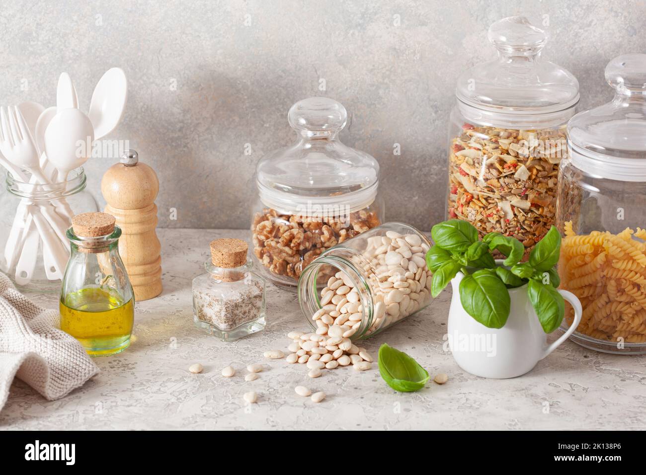 kitchen utensils on modern simple counter, kitchenware jars with dry ...