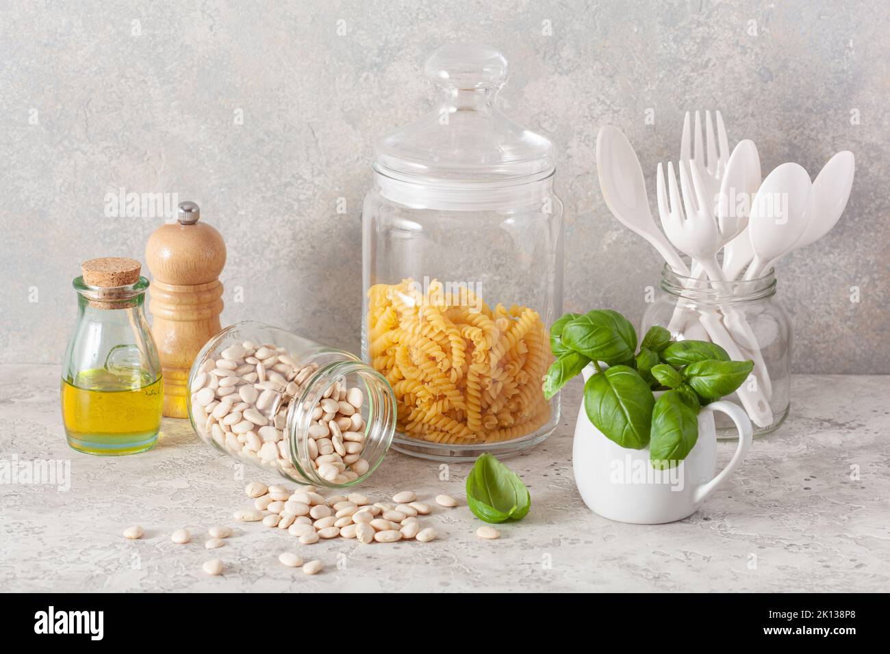 kitchen utensils on modern simple counter, kitchenware jars with dry ...