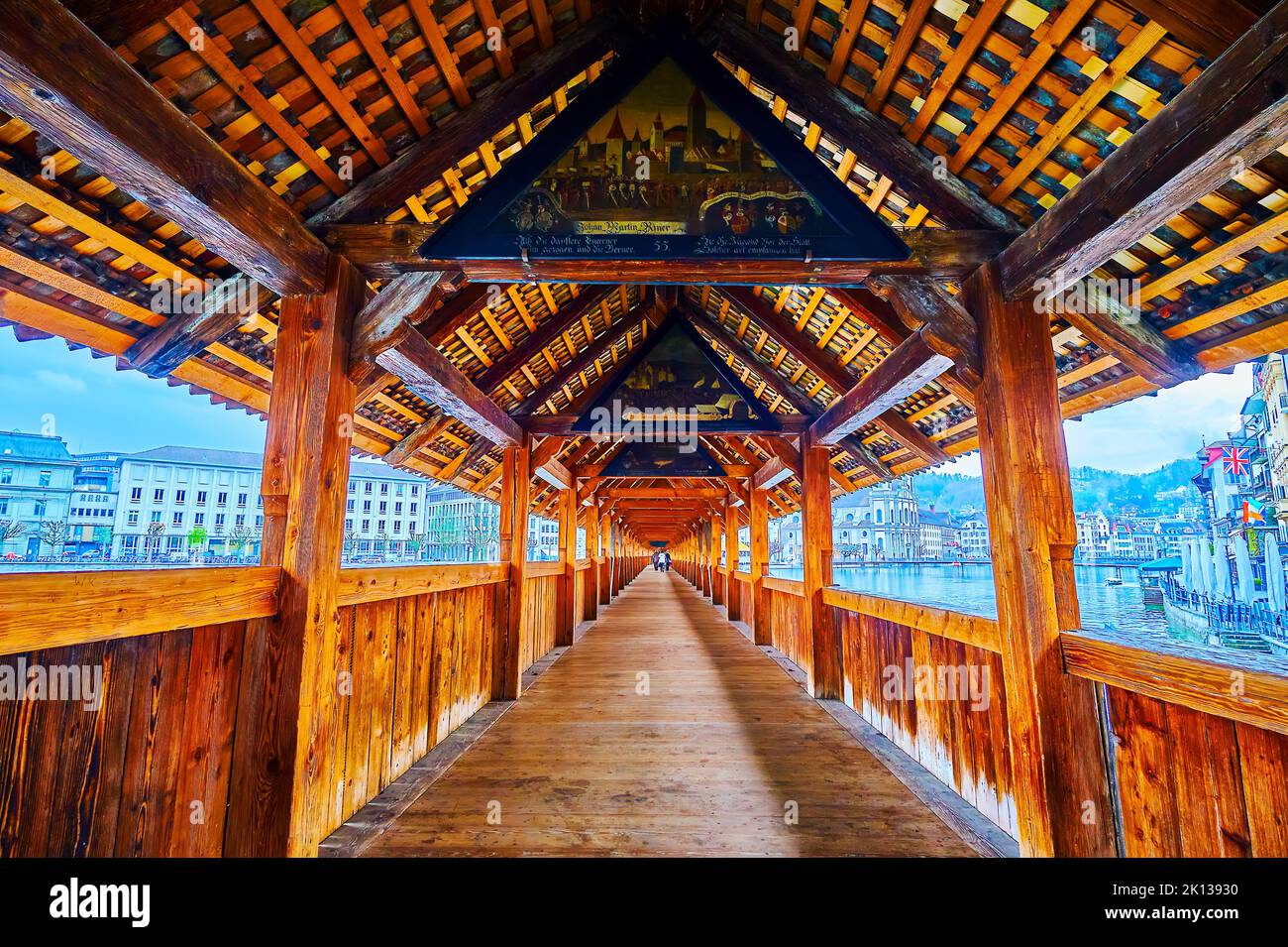 Stroll along the covered Kapellbrucke bridge enjoying medieval pictures ...