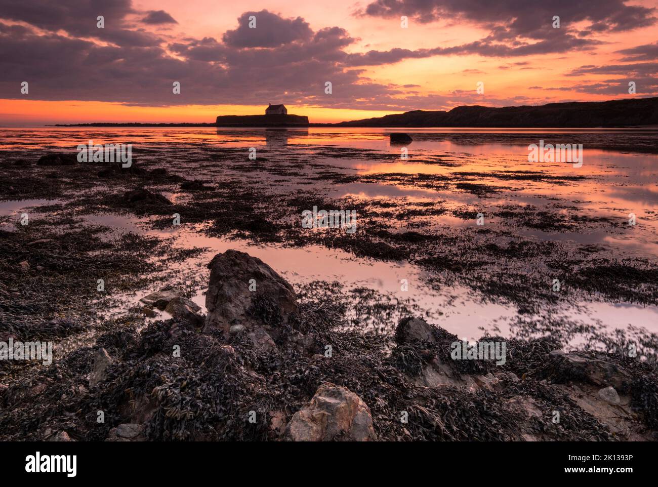 St. Cwyfan's Church on the island of Cribinau at sunset, near Aberffraw ...