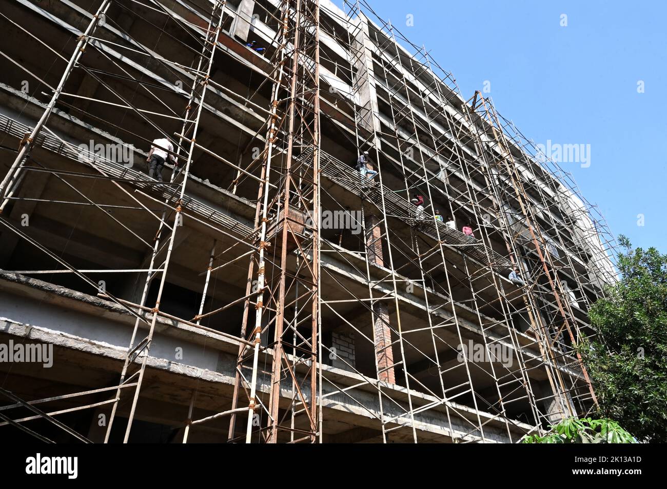 Construction workers on a prime location scaffolded building site in ...