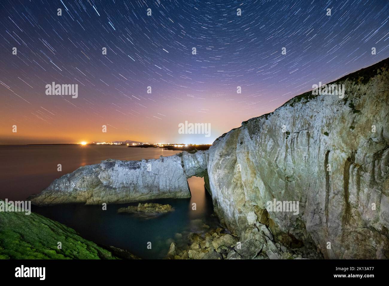 Star trails and night sky over Bwa Gwyn or the White Arch, near ...