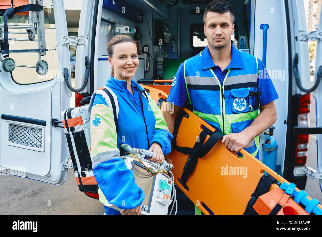 Personnel of emergency service with first aid medical equipment rushes ...
