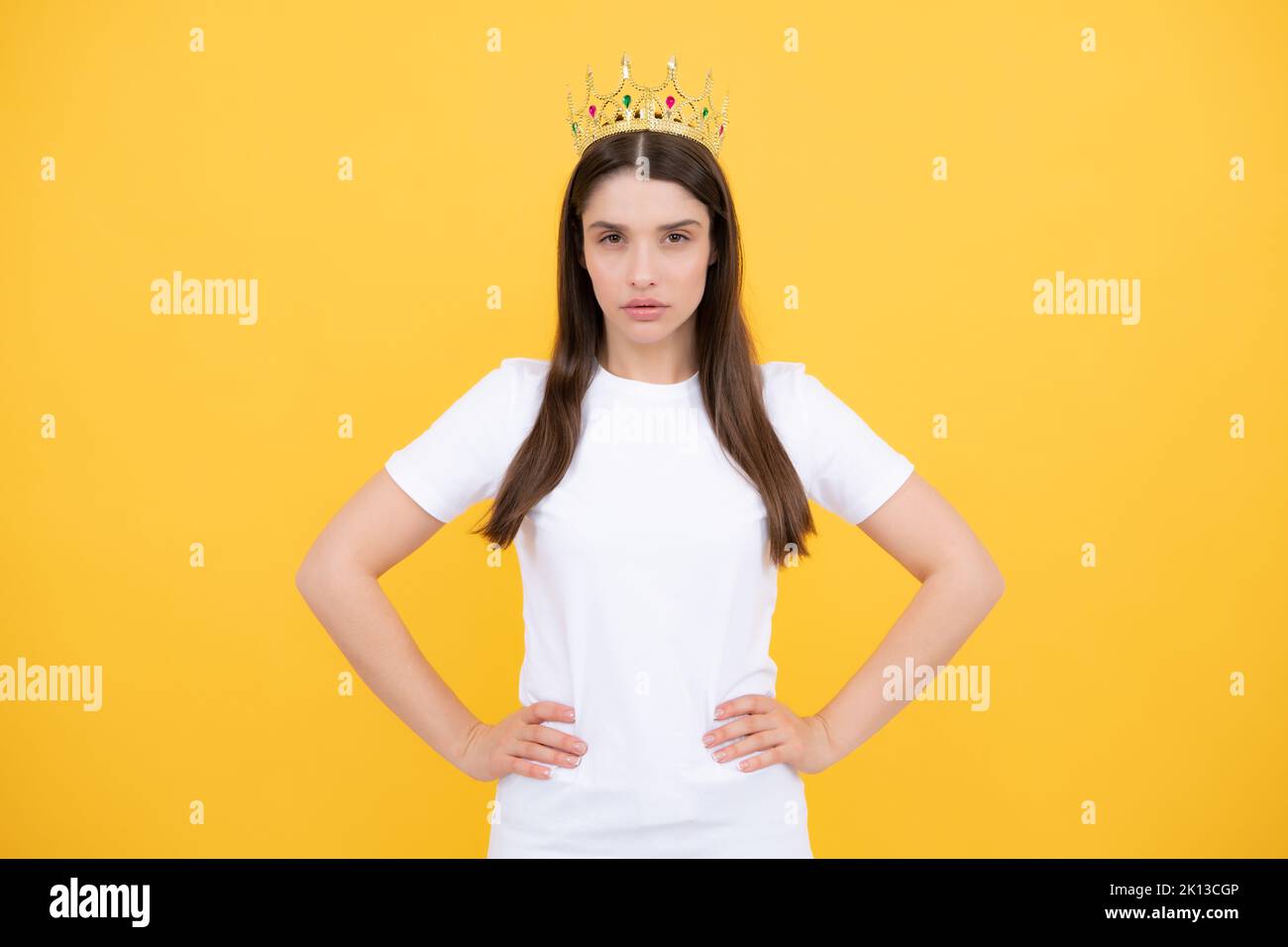 Young lovely woman in crown on yellow background. Girl with queen crown ...