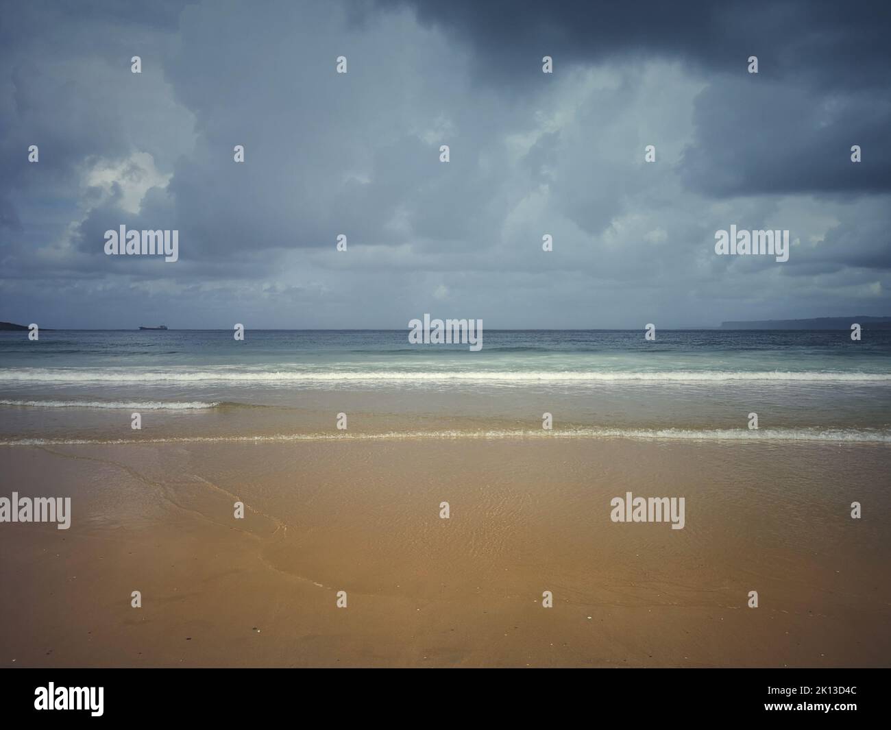 An empty beach of Playa del Sardinero in Santander, Spain under a ...