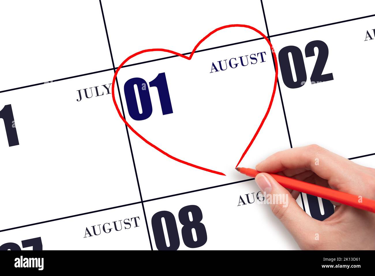 1st day of August. A woman's hand drawing a red heart shape on the ...