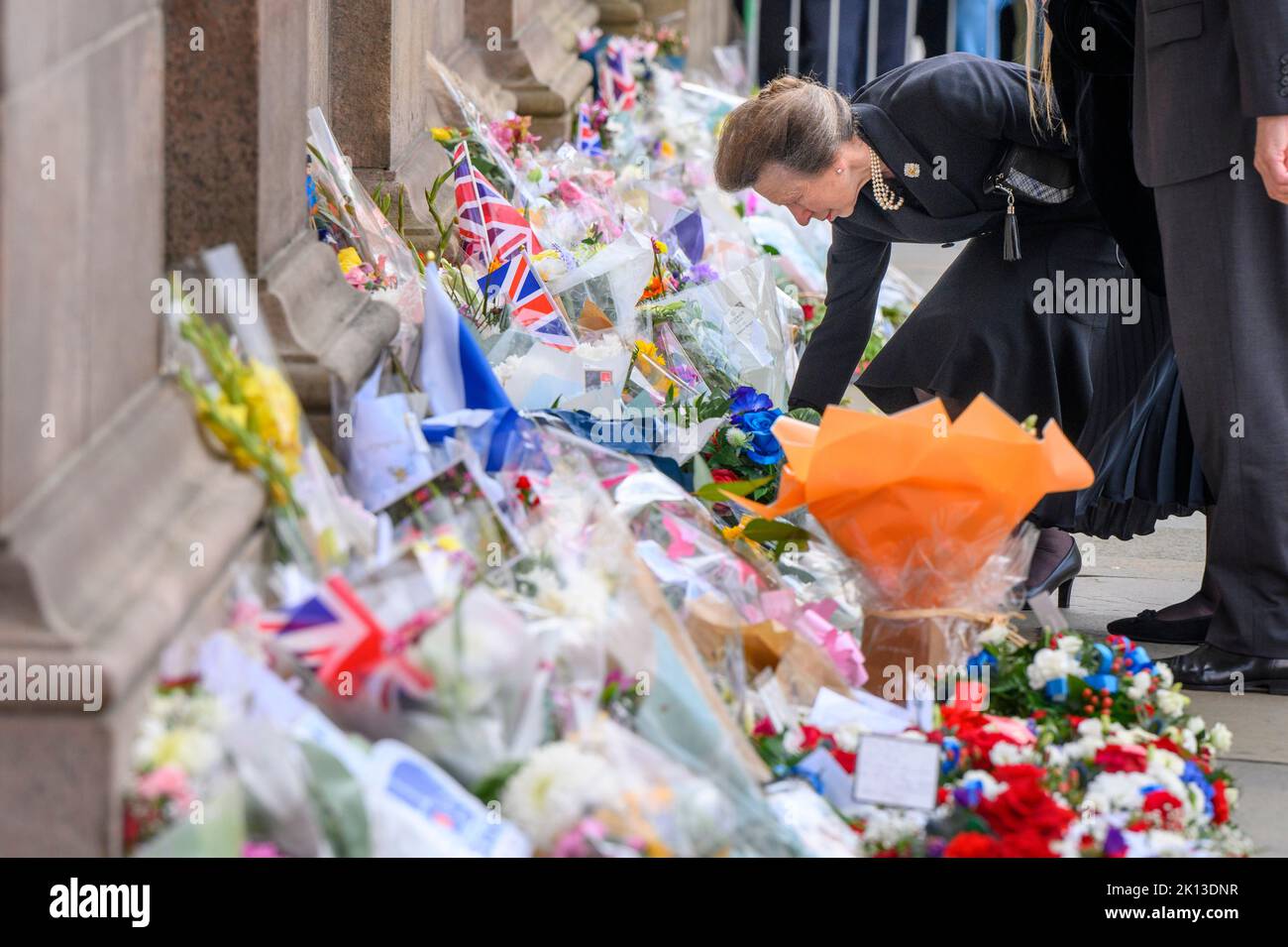 The Princess Royal looks at floral tributes during a visit to Glasgow ...