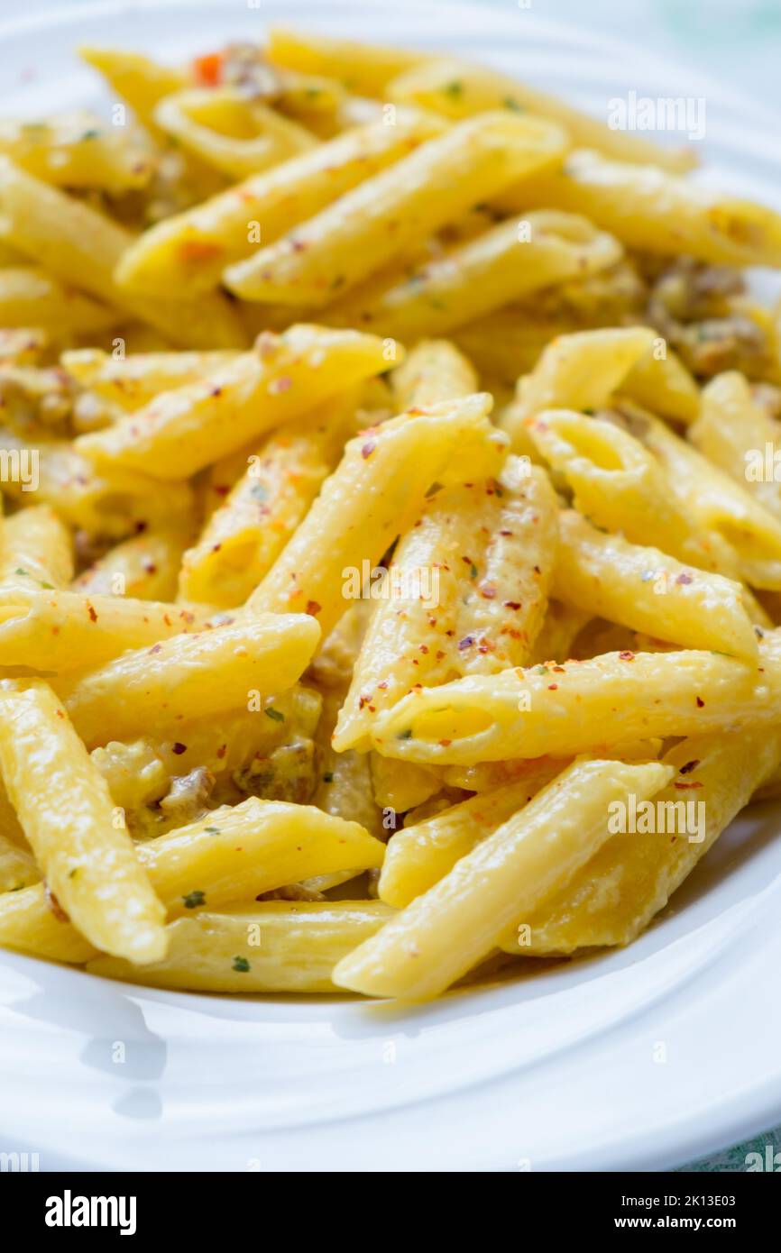 A vertical closeup shot of a gourmet dish of cheesy penne pasta Stock ...