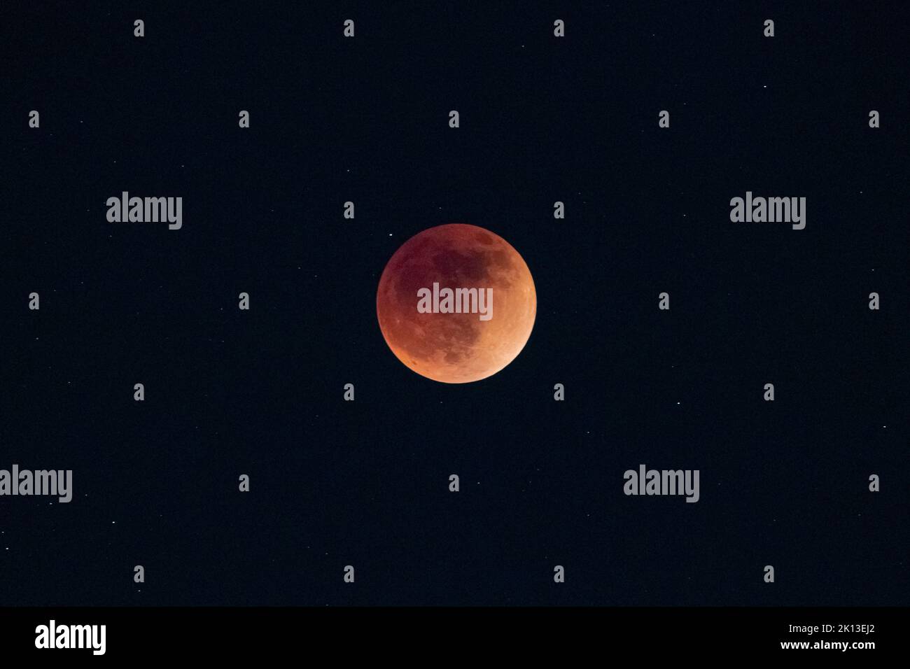 A blood moon total lunar eclipse super moon rising against dark sky Stock Photo - Alamy