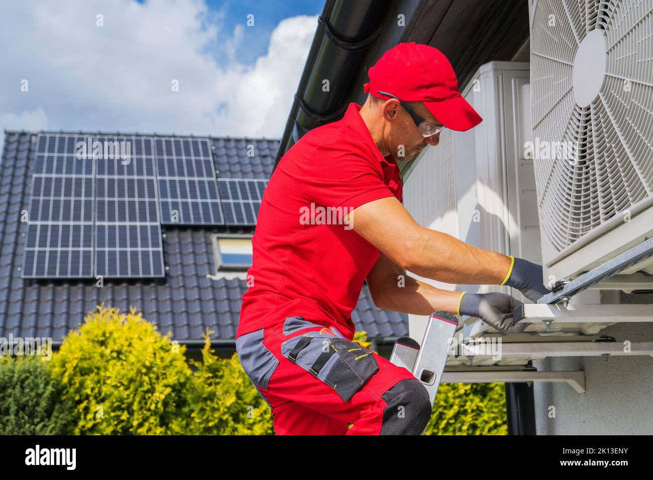 HVAC Worker Performing Heat Pump Maintenance. Device is Transferring ...