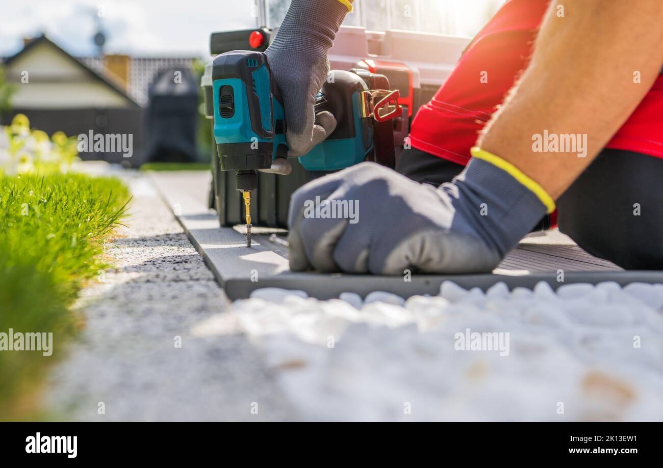 Backyard Garden Turf Grass Installation. Assembling Composite Elements ...