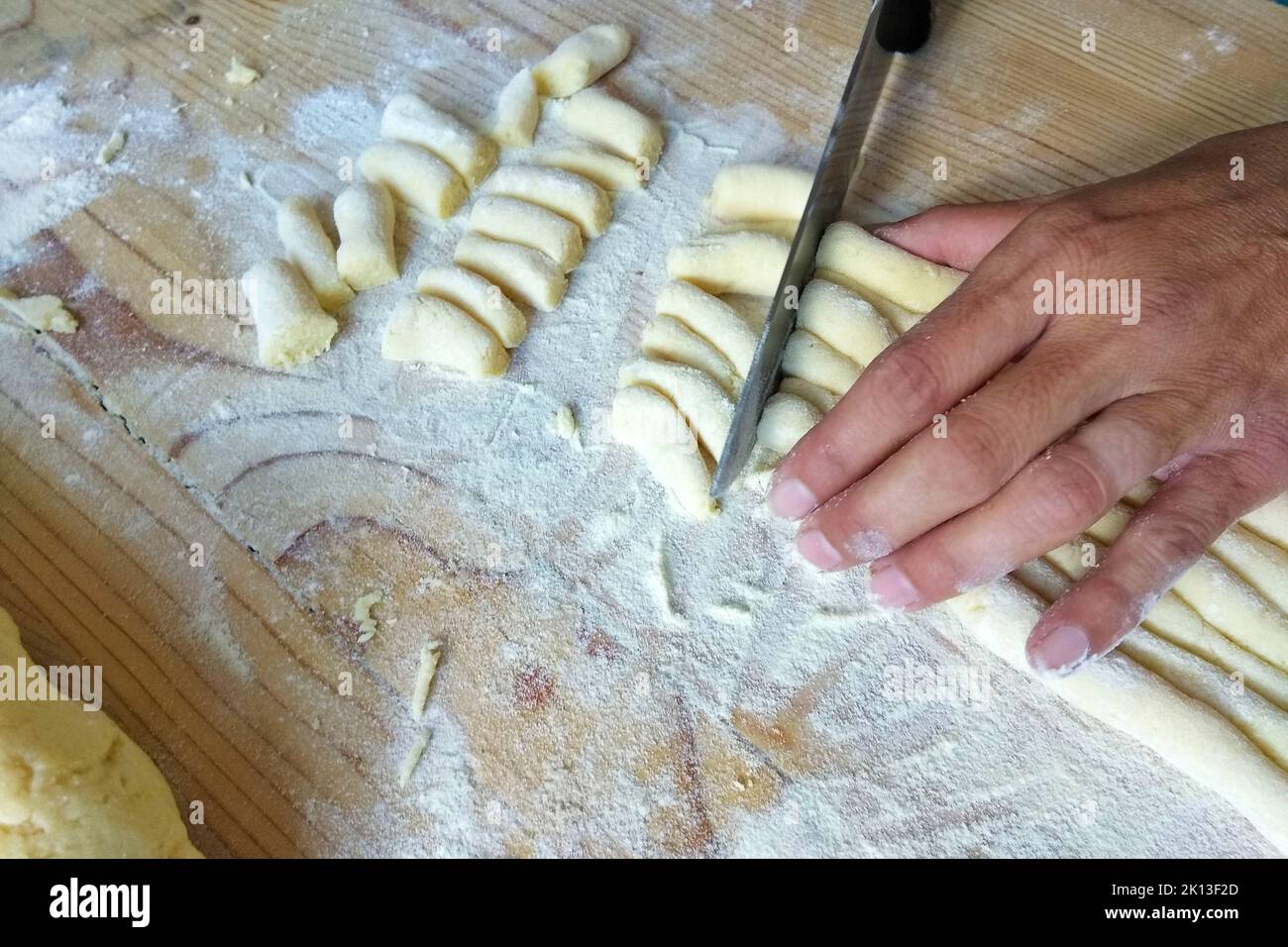 A mans hand cutting a dough Stock Photo - Alamy