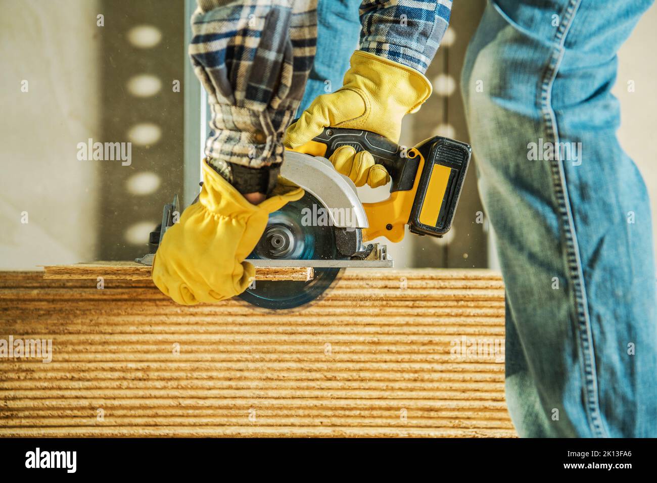 Closeup of Carpenter Cutting Wooden Planks Using Electric Cordless Hand ...