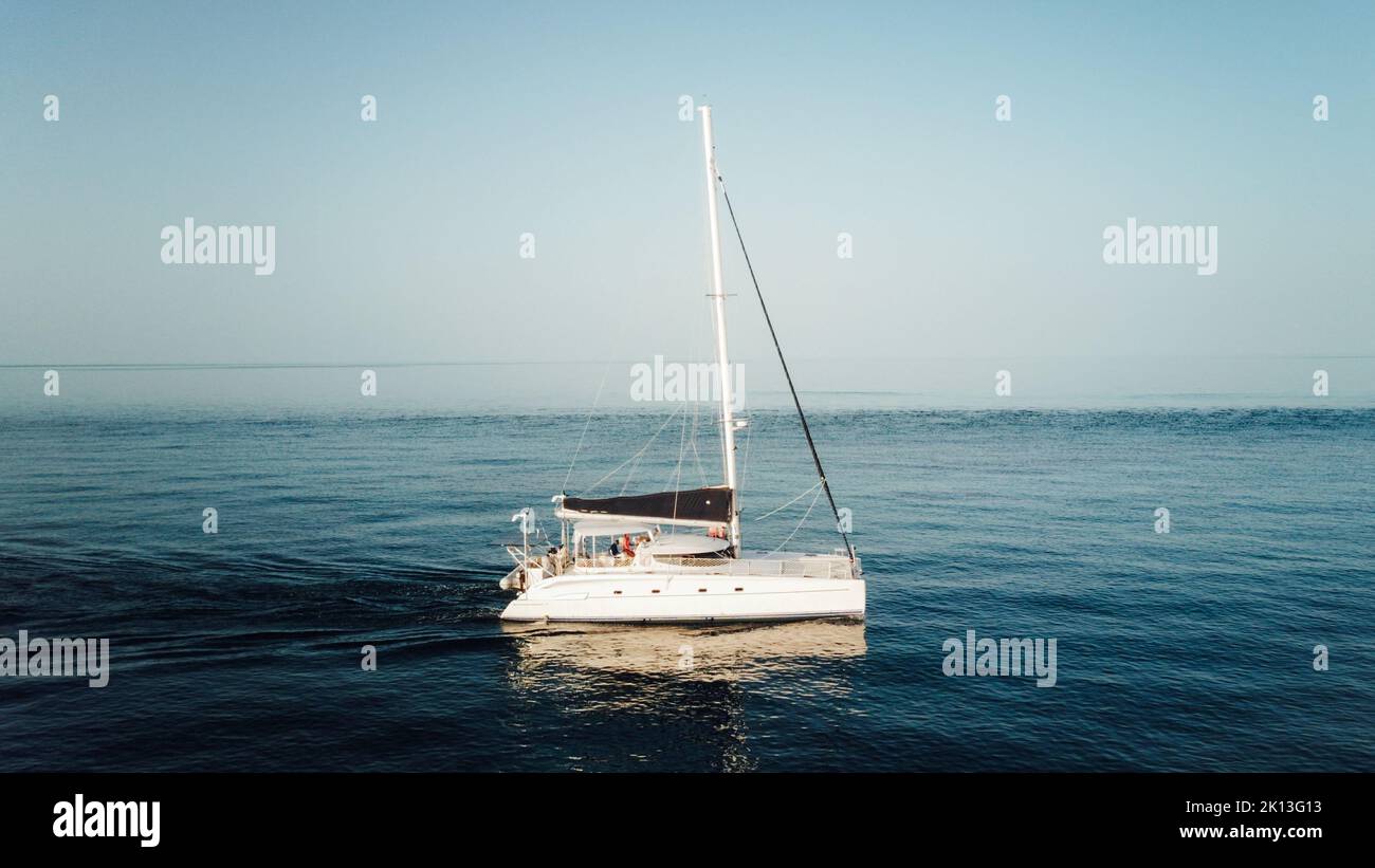 A Catamaran sailboat on the blue calm ocean in the Bahamas Stock Photo ...
