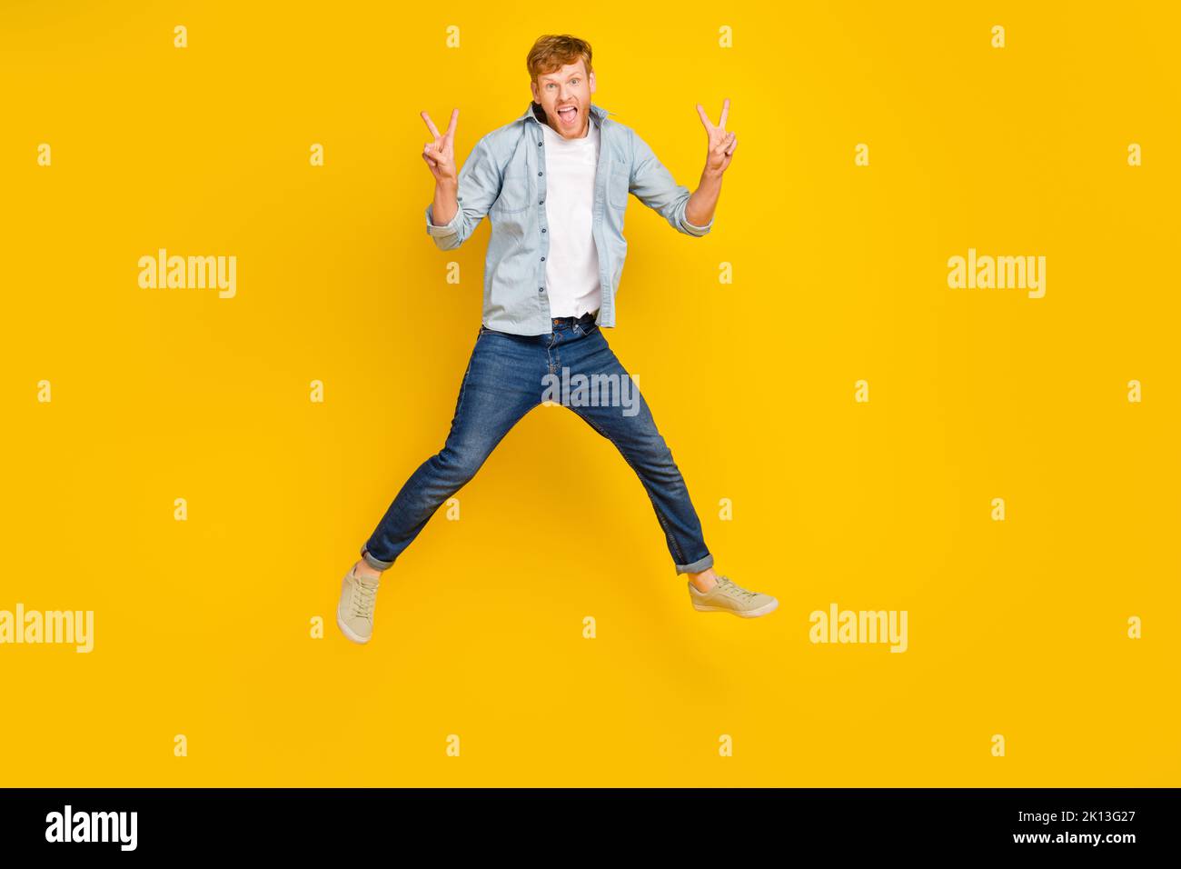 Full length photo of impressed handsome guy blue shirt jeans sneakers ...
